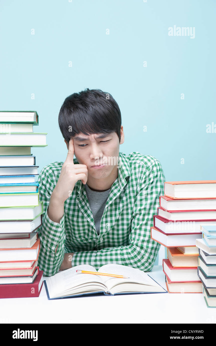 Studying man at the desk Stock Photo - Alamy