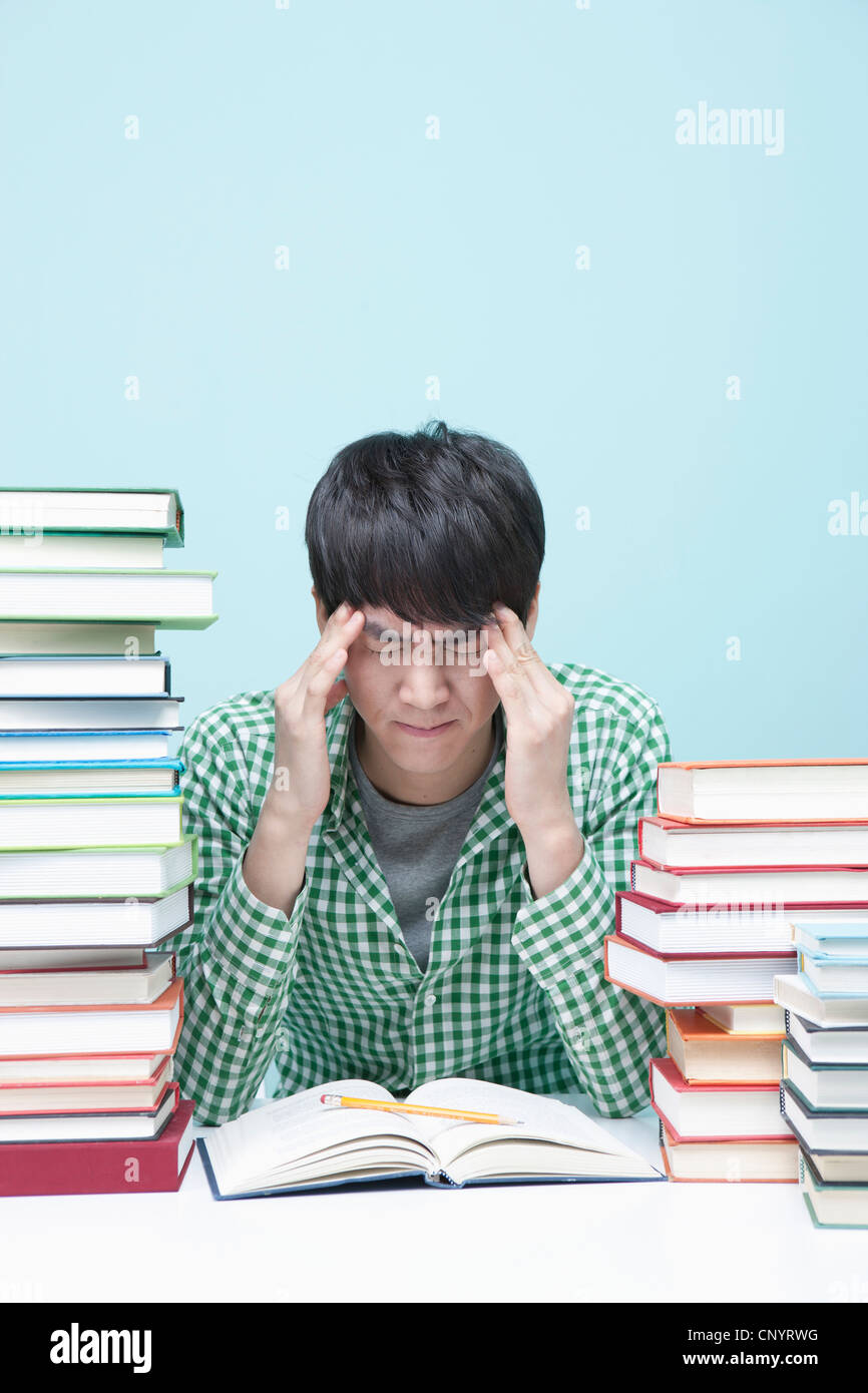 Stressful man while studying at the desk Stock Photo - Alamy