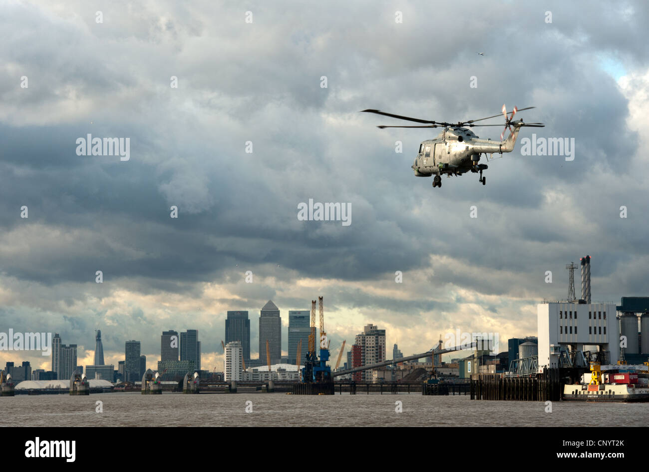 A Royal Navy helicopter flies over the river Thames in London during a ...
