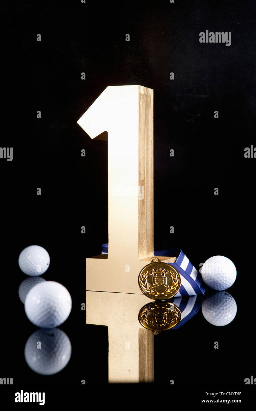 The golden number one, golf ball, and prize medal Stock Photo - Alamy