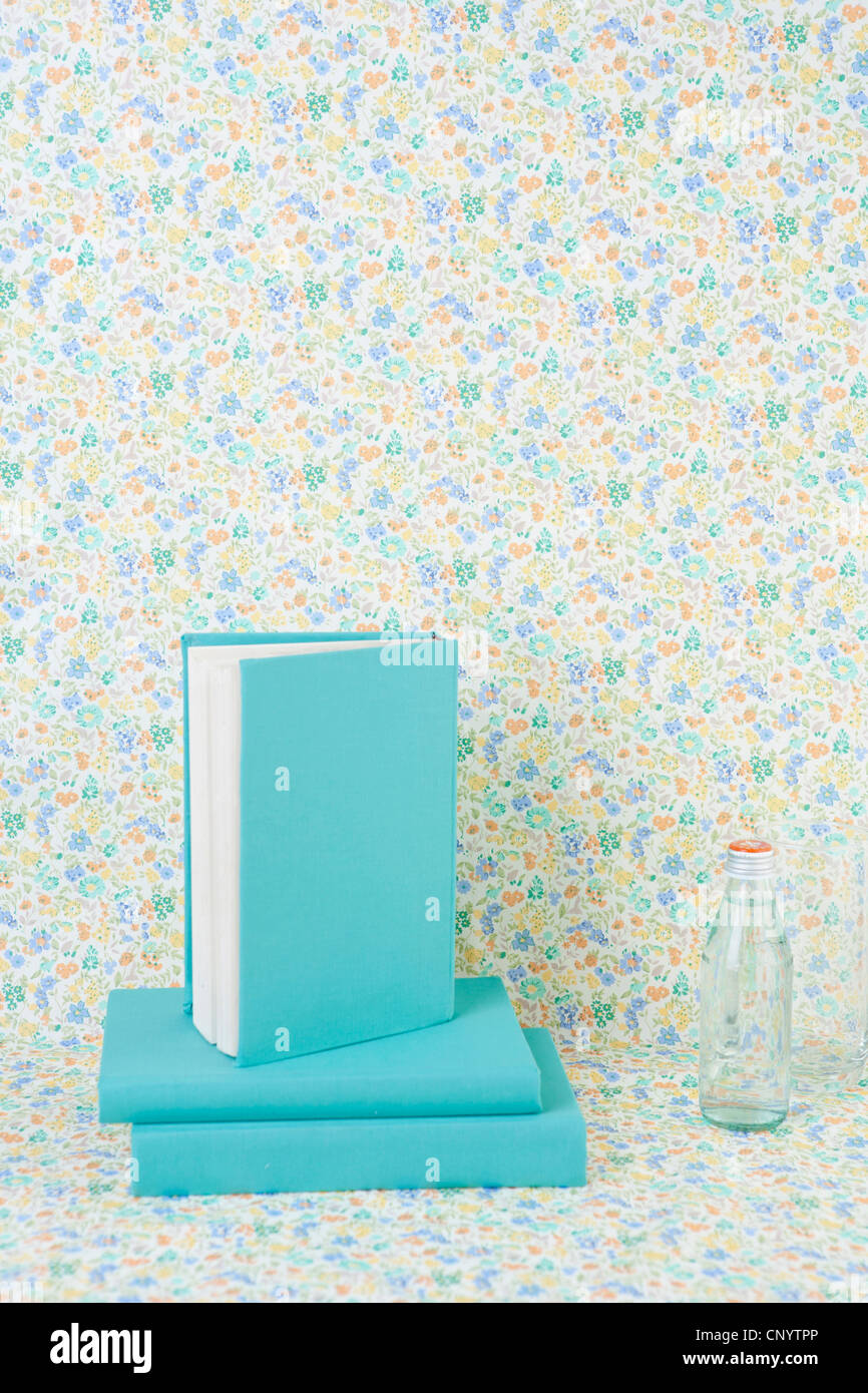The blue cover book and the glass bottle Stock Photo - Alamy