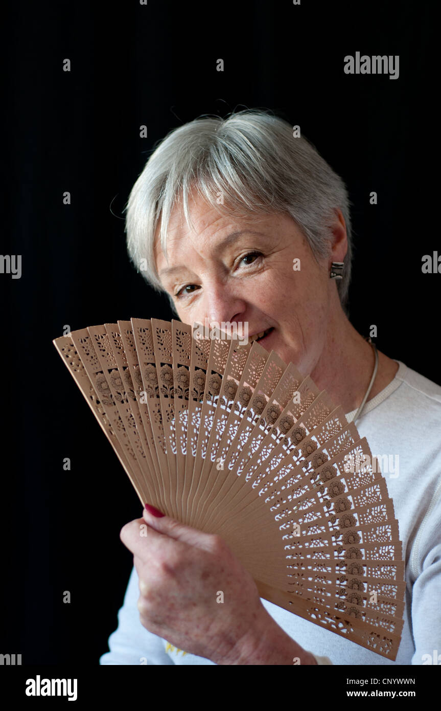 Middle aged woman with a fan Stock Photo - Alamy