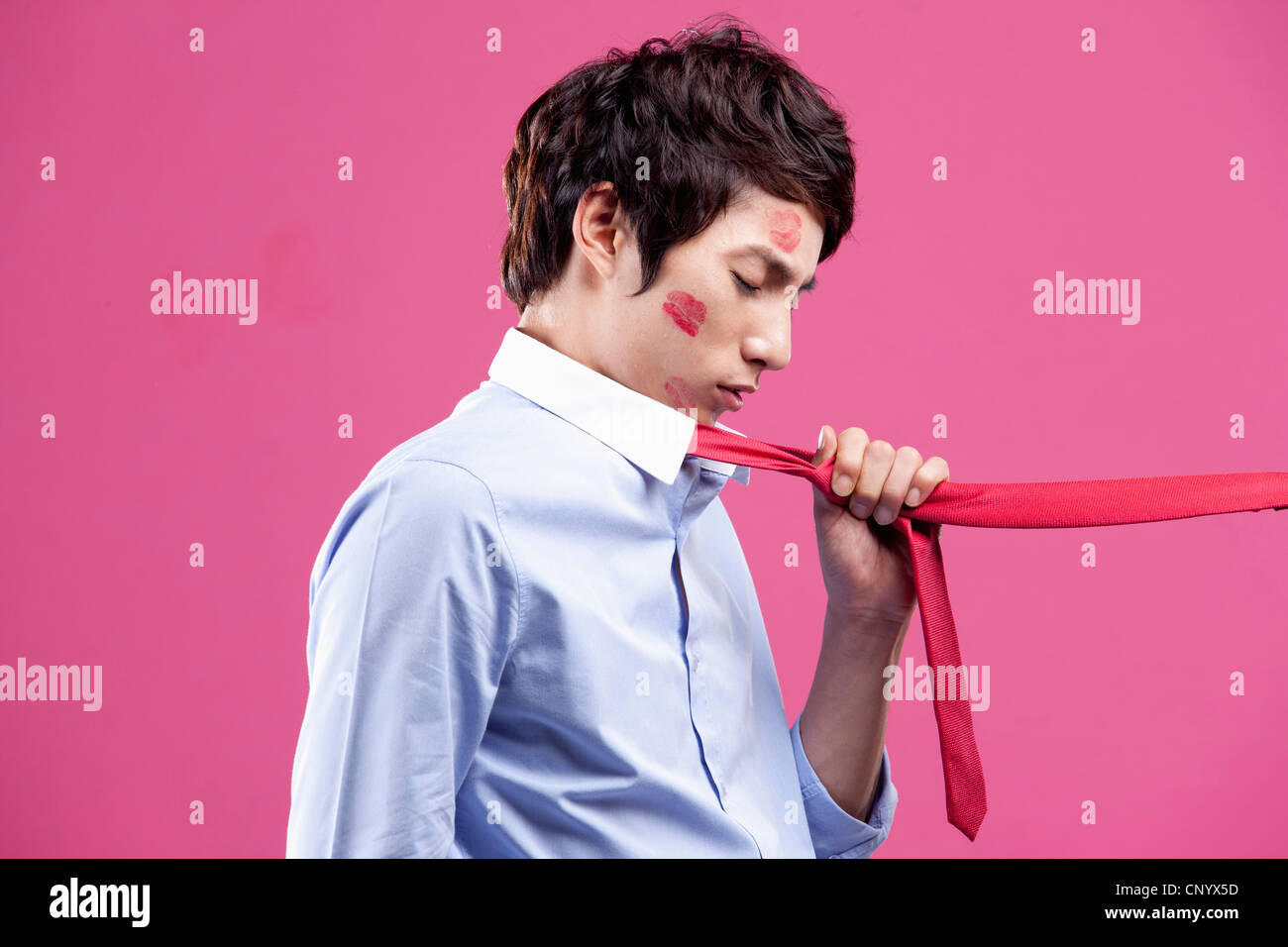 A man pulled with his red tie Stock Photo - Alamy