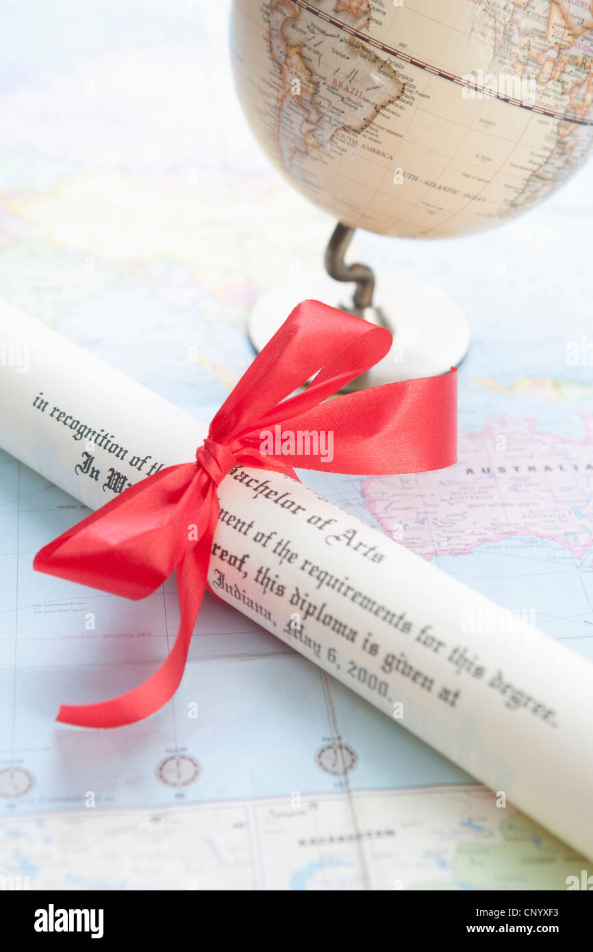 The diploma and globe on the world map Stock Photo - Alamy