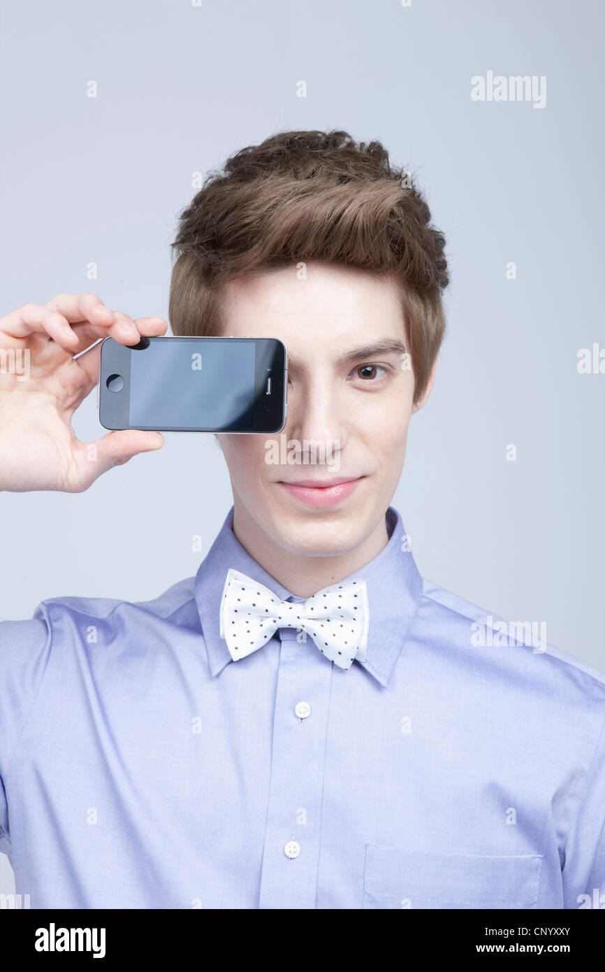 A man holding the smart phone over his face Stock Photo - Alamy
