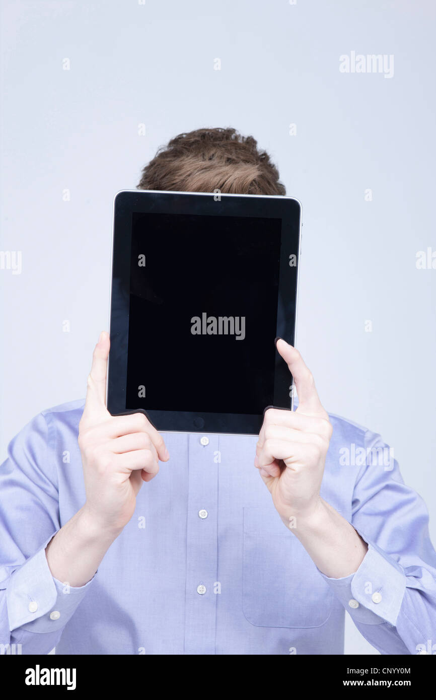 A man holding the tablet PC over his face Stock Photo - Alamy