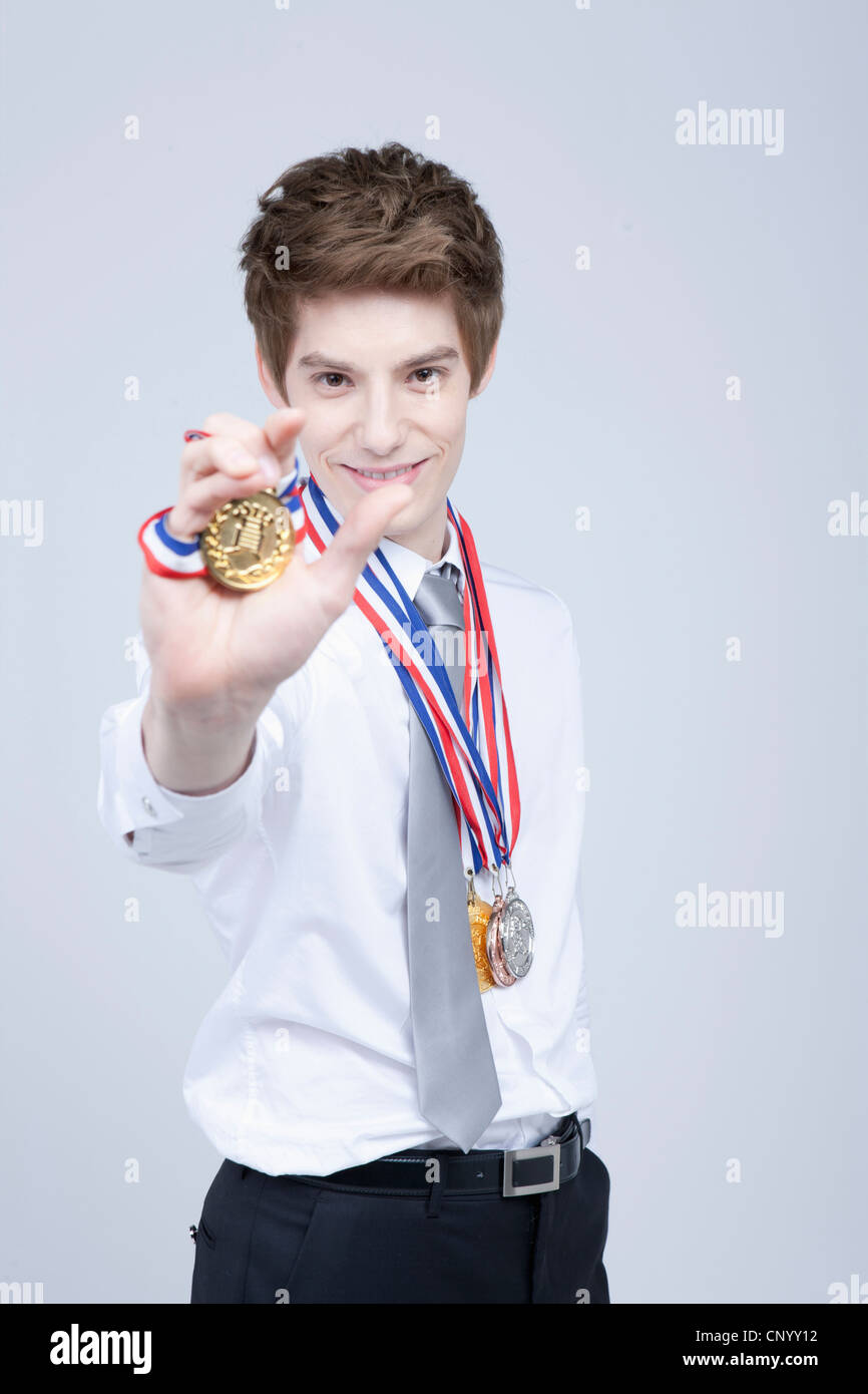 A man holding the prize medal Stock Photo - Alamy