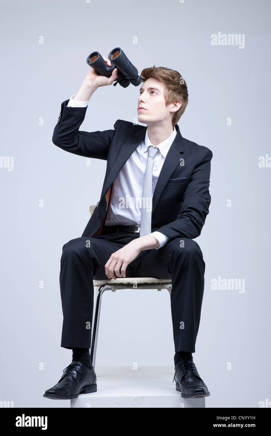 A man looking through the telescope Stock Photo - Alamy