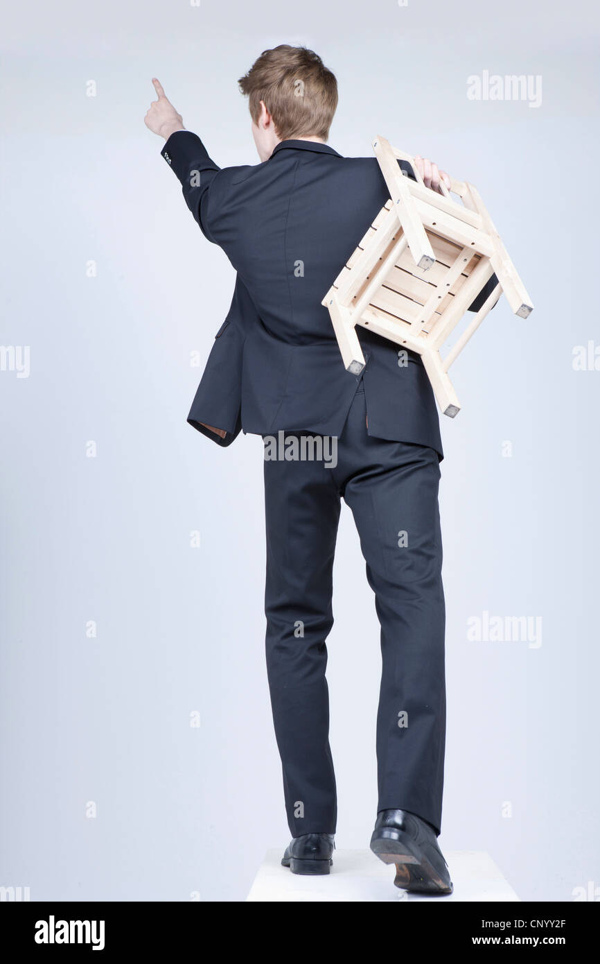 A man walking with the chair Stock Photo - Alamy