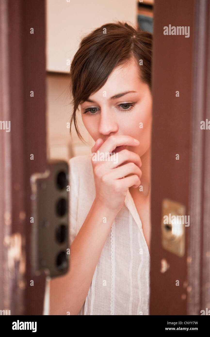 scared woman at the front door Stock Photo - Alamy