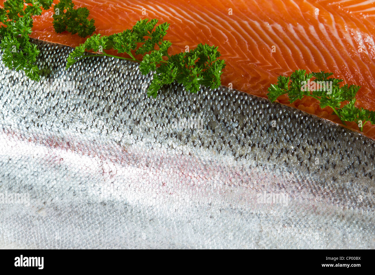 Wild caught trout fillets showing skin and red meat with parsley Stock ...