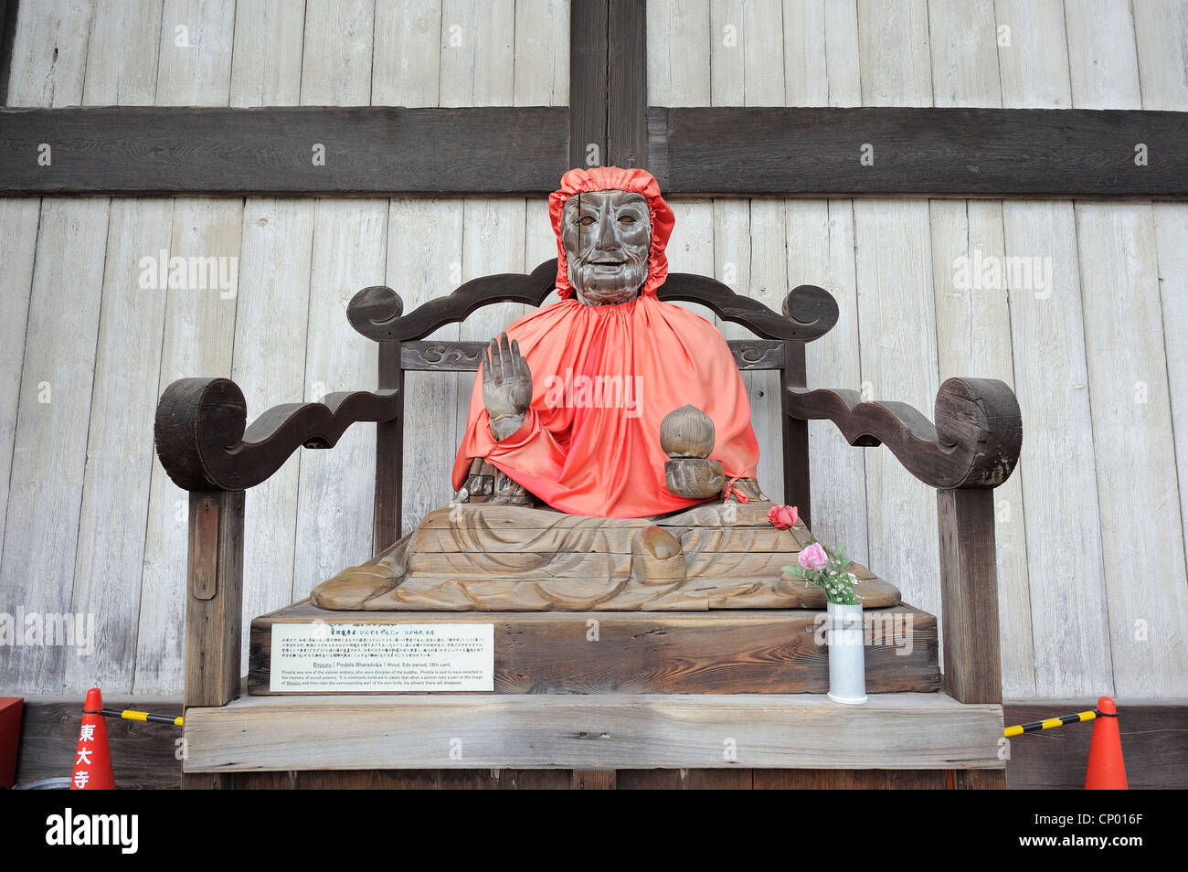 wooden Pindola sculpture with red cape at Todaiji temple, Nara, Japan ...
