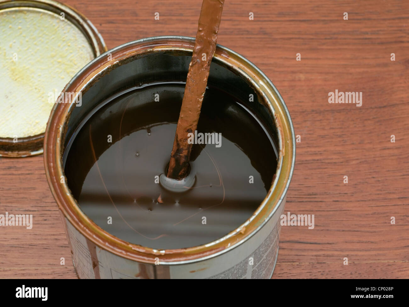 brown paint pot with wooden stick Stock Photo - Alamy