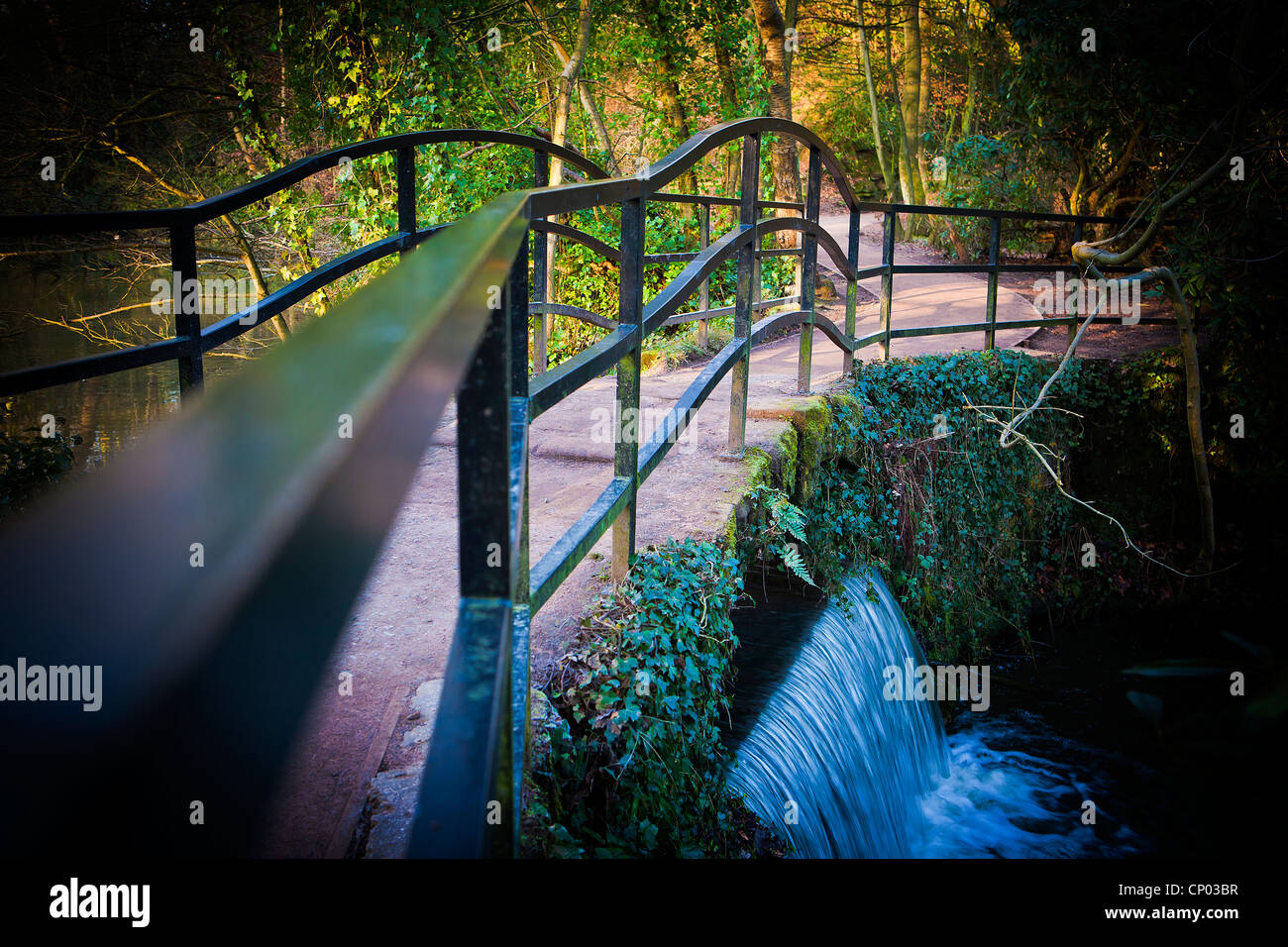Wishing Bridge with metal handrails over the weir between Lymm Upper ...