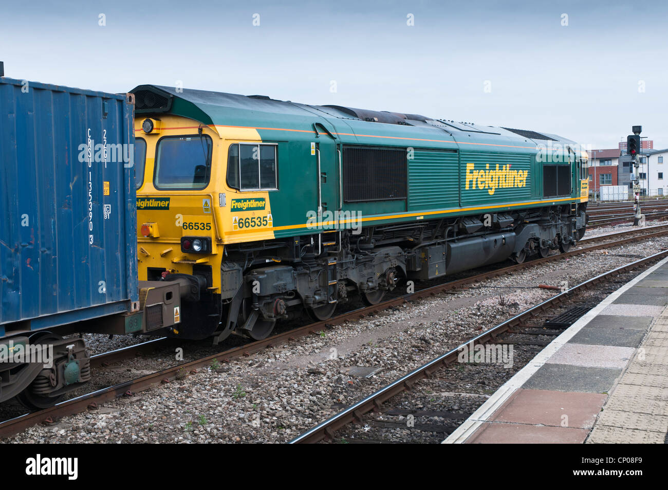 A Freightliner Class 66 locomotive waiting at a red signal heading a ...