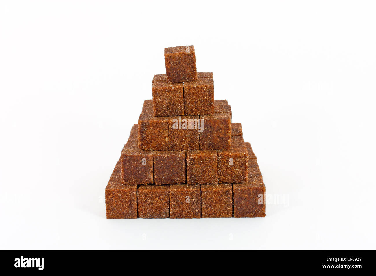 Pyramid made of cane sugar cubes isolated on white Stock Photo - Alamy
