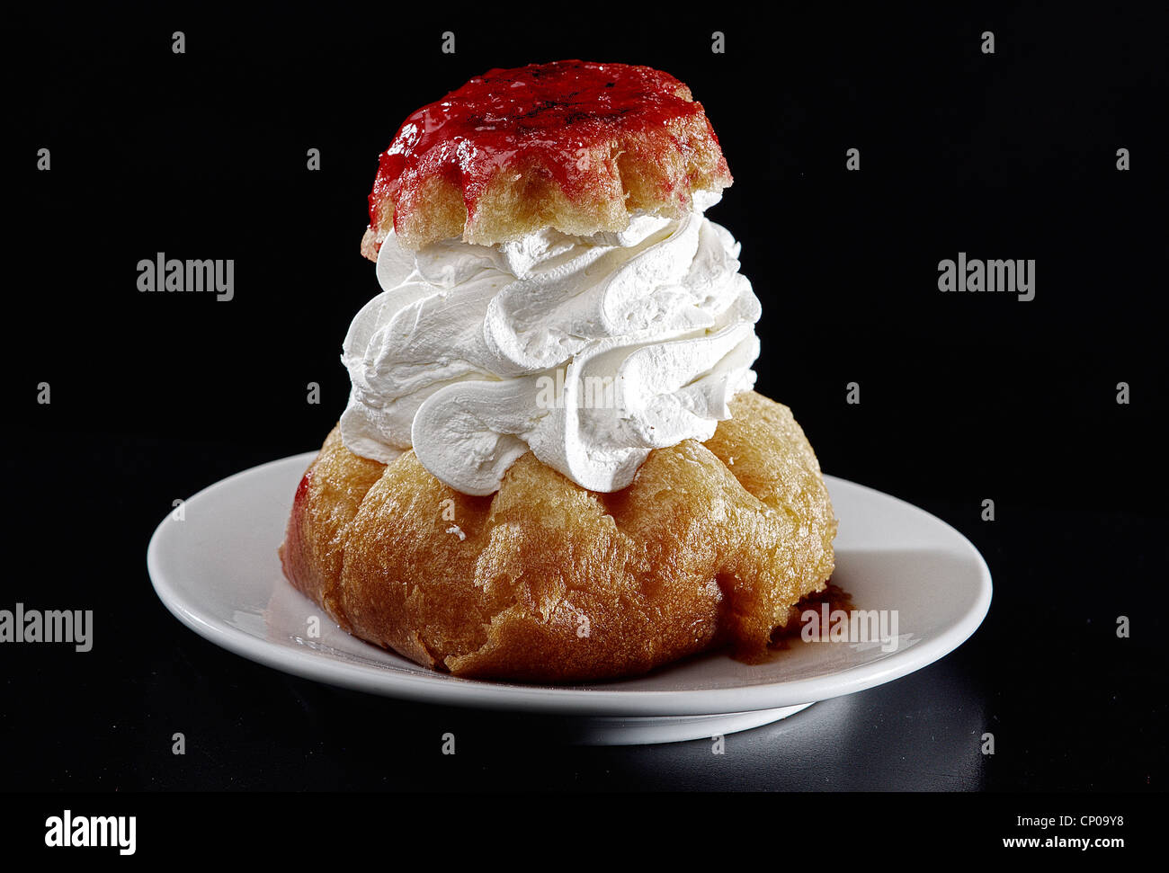 Rum baba with cherry syrup Stock Photo - Alamy
