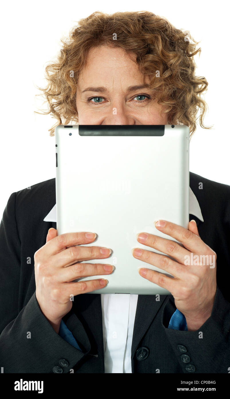 Corporate lady hiding her face with ipad, smiling at camera Stock Photo ...