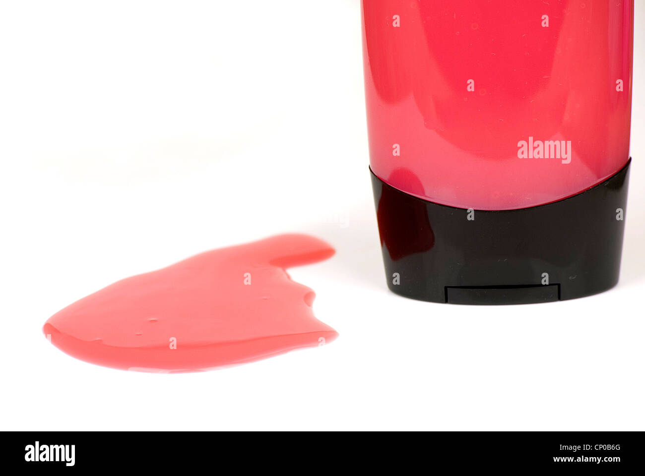 red colored shower gel bottle and squeezed sample isolated on white ...