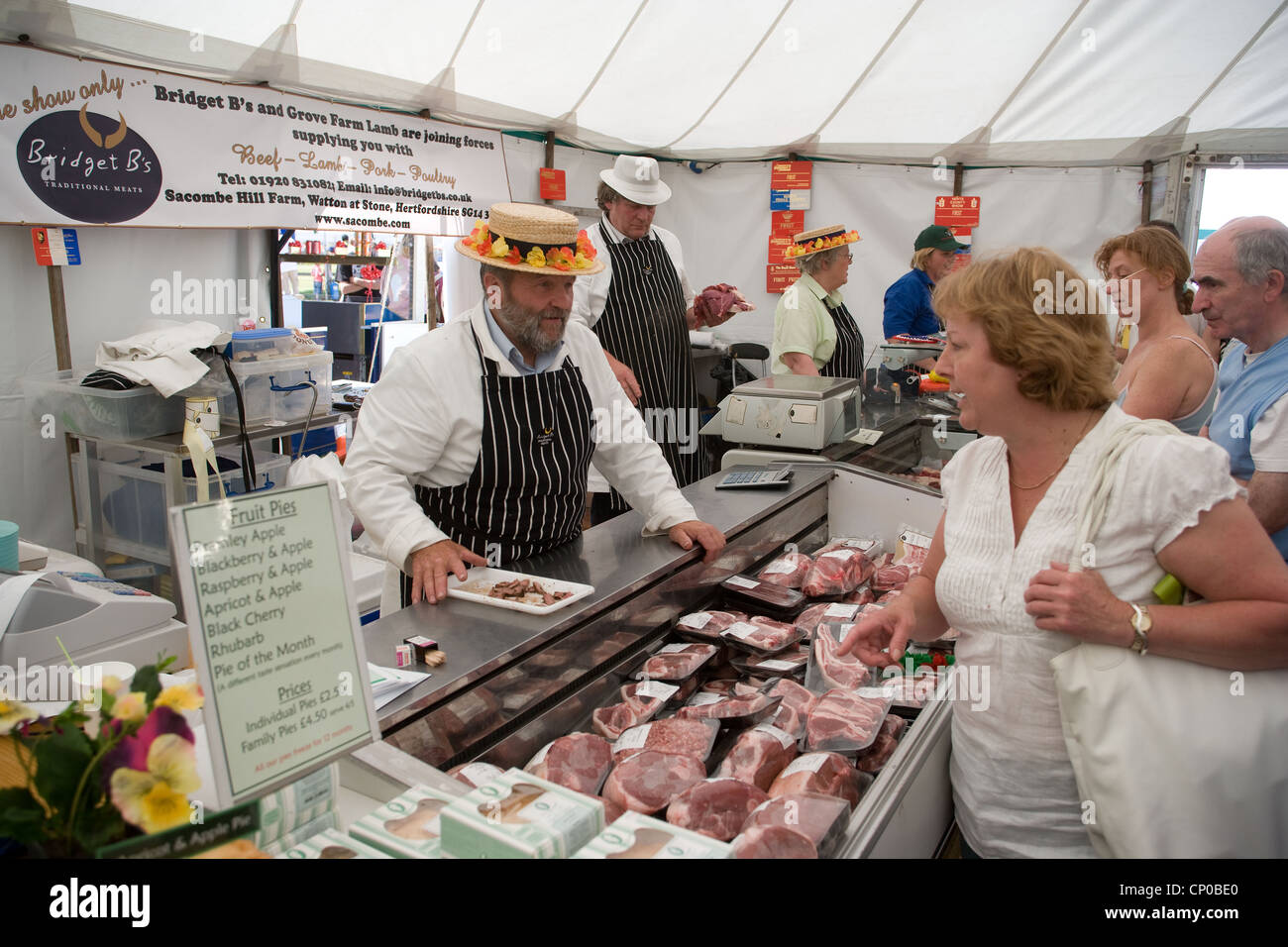 A Butchers stand at a food fair Stock Photo - Alamy