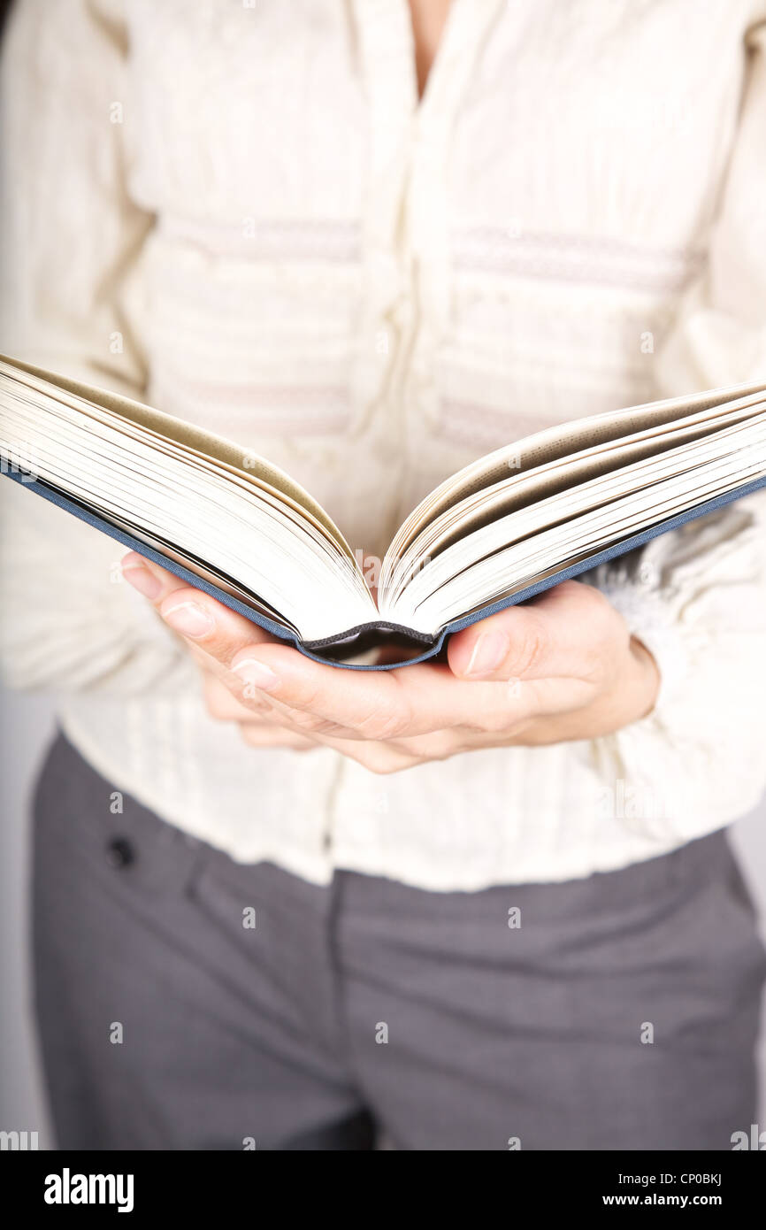 woman white shirt detail holding an open book Stock Photo - Alamy