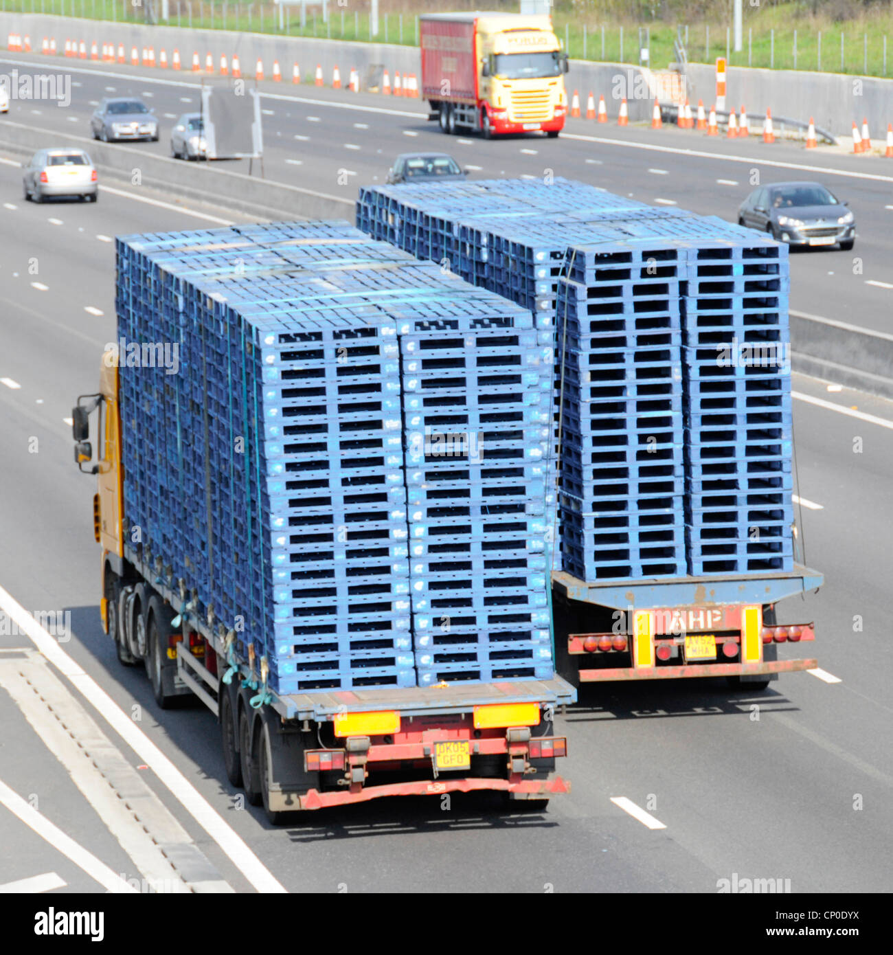 Back view Trucks Lorries & articulated flat bed trailers overtaking ...