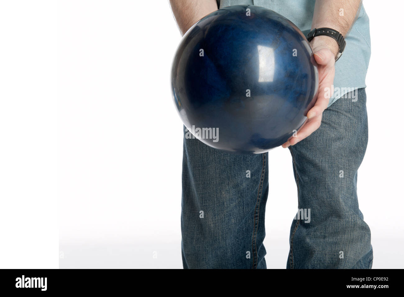 man holds a dark blue marbled bowling ball isolated on white Stock ...