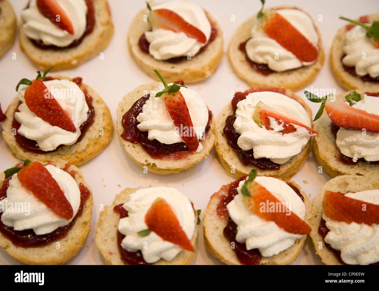 Strawberry and cream scones tea jam fruit fancies Stock Photo - Alamy