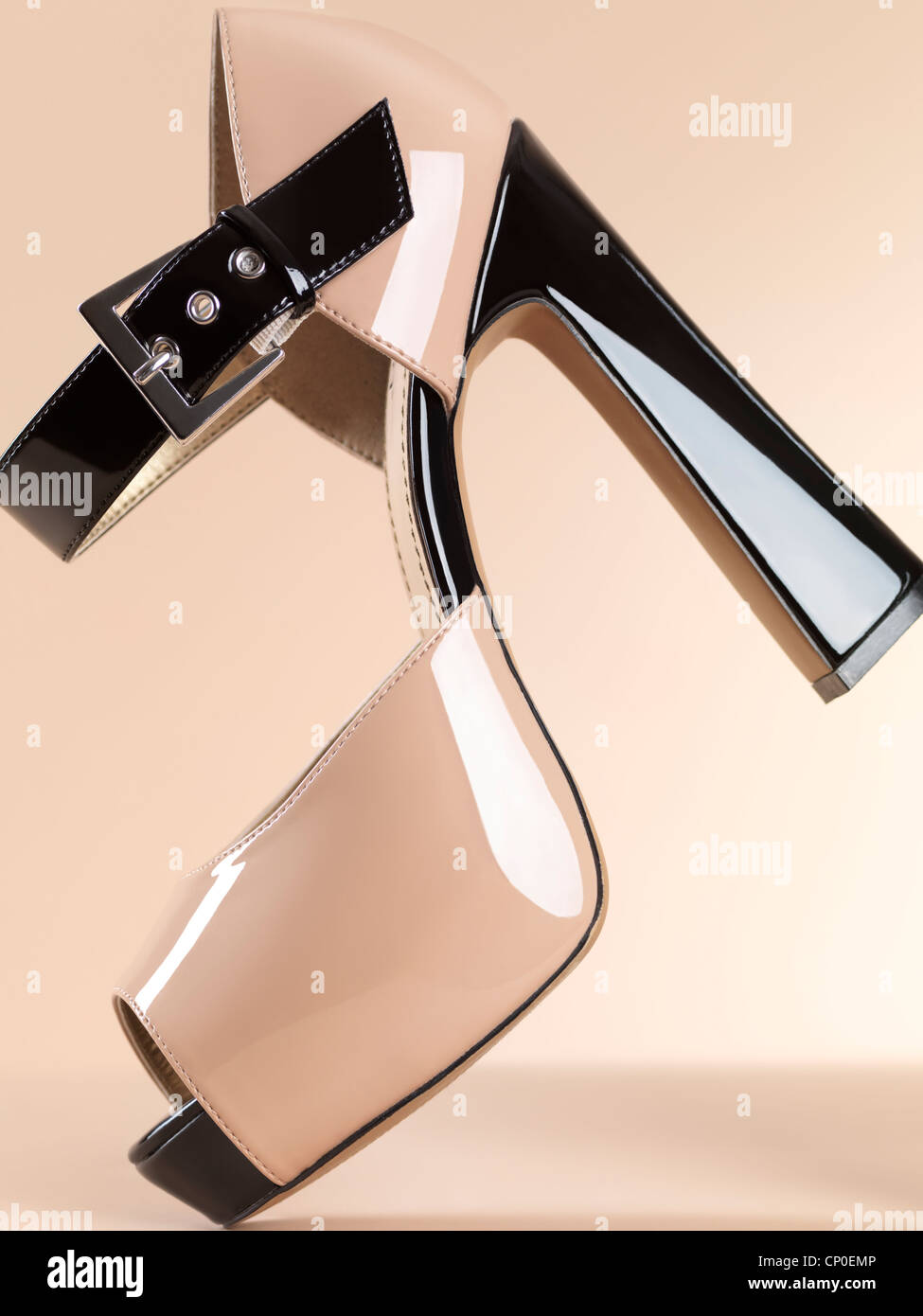 Closeup of a trendy thick high heel platform shoe isolated on beige ...