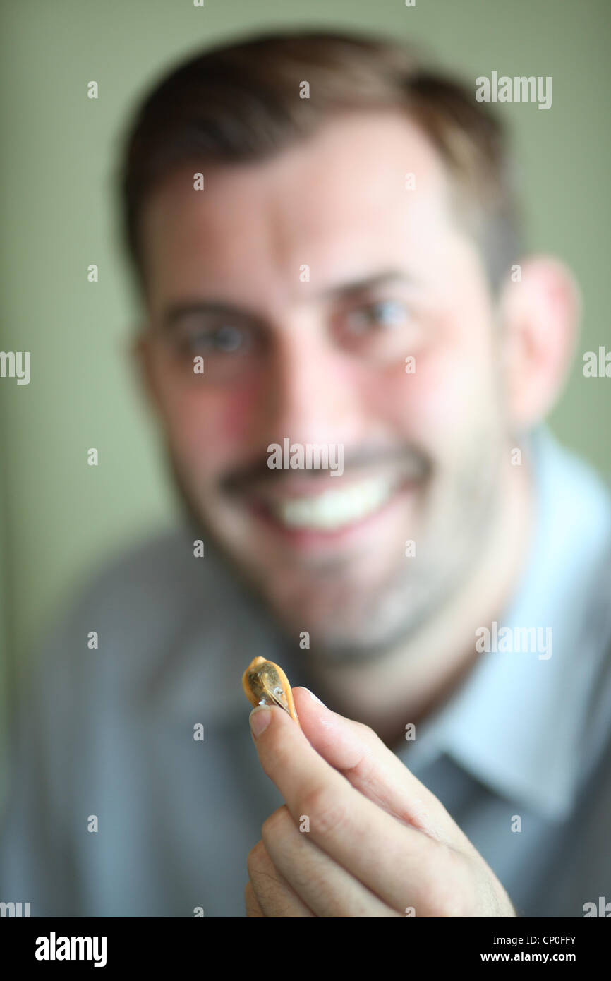 British chef Mark Sargent holds a freshly steamed mussel Stock Photo ...
