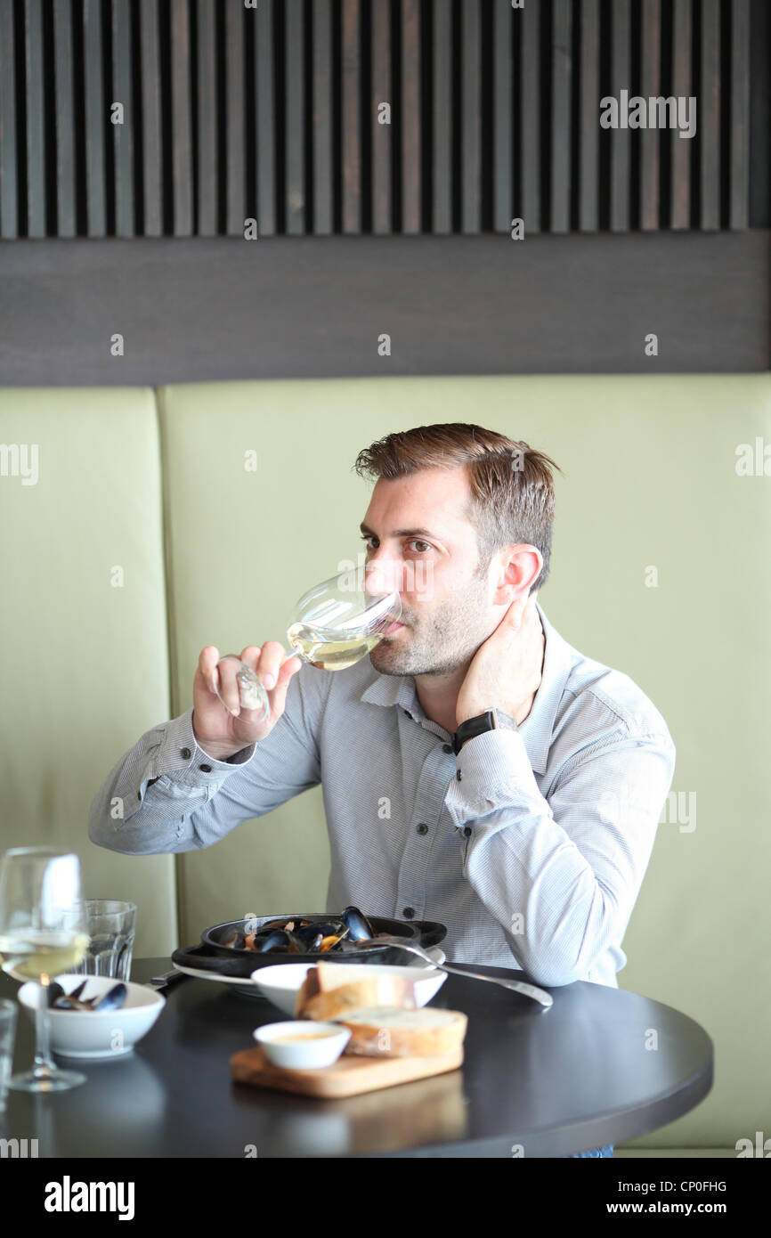 British chef Mark Sargent drinks a glass of white wine with his meal ...