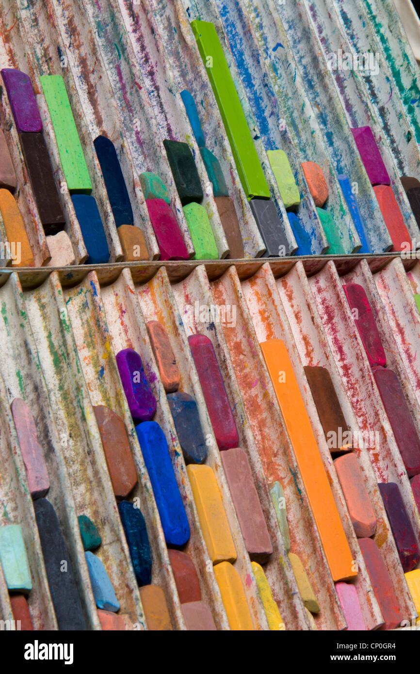Close-up, angled view of large box of used, colored artist pastel ...