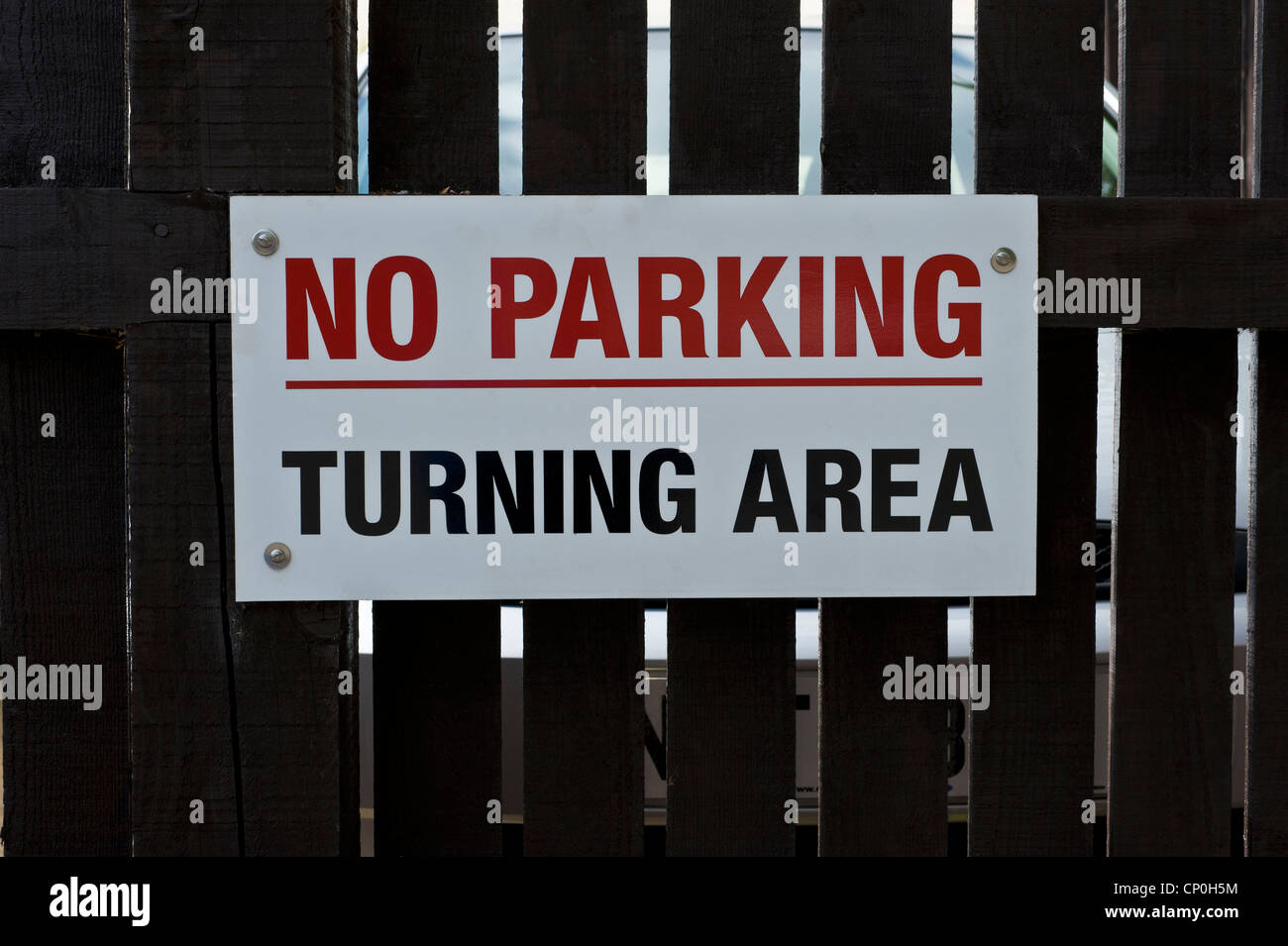 Sign post in red and black showing no parking for a turning area with ...