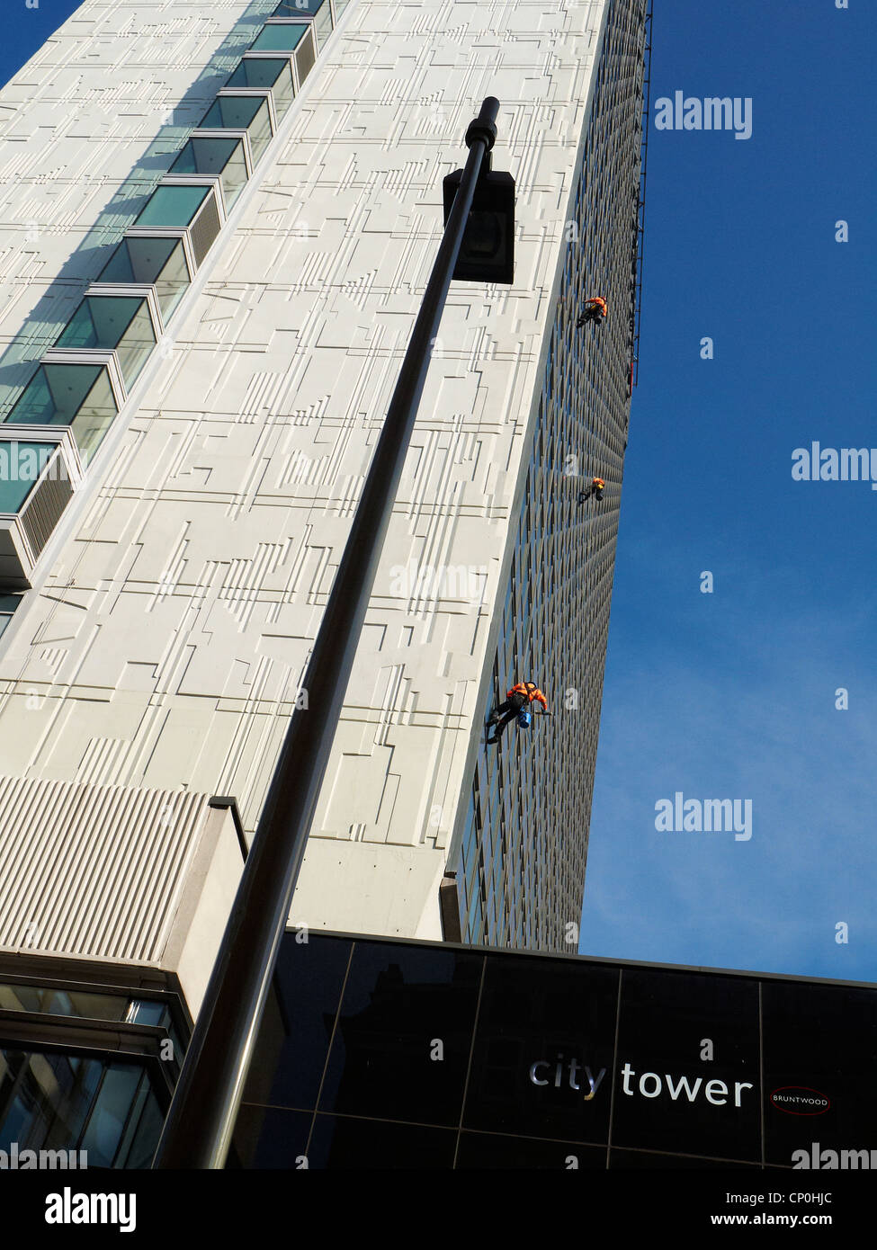 Three window cleaners outside City Tower in Manchester UK Stock Photo ...