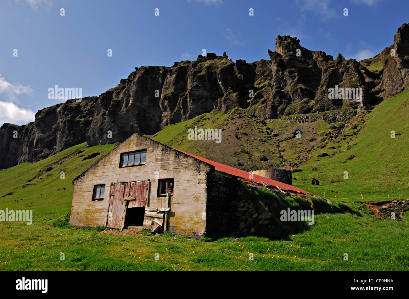 Barn or sheep-shed beneath basalt crags near the farming township of ...