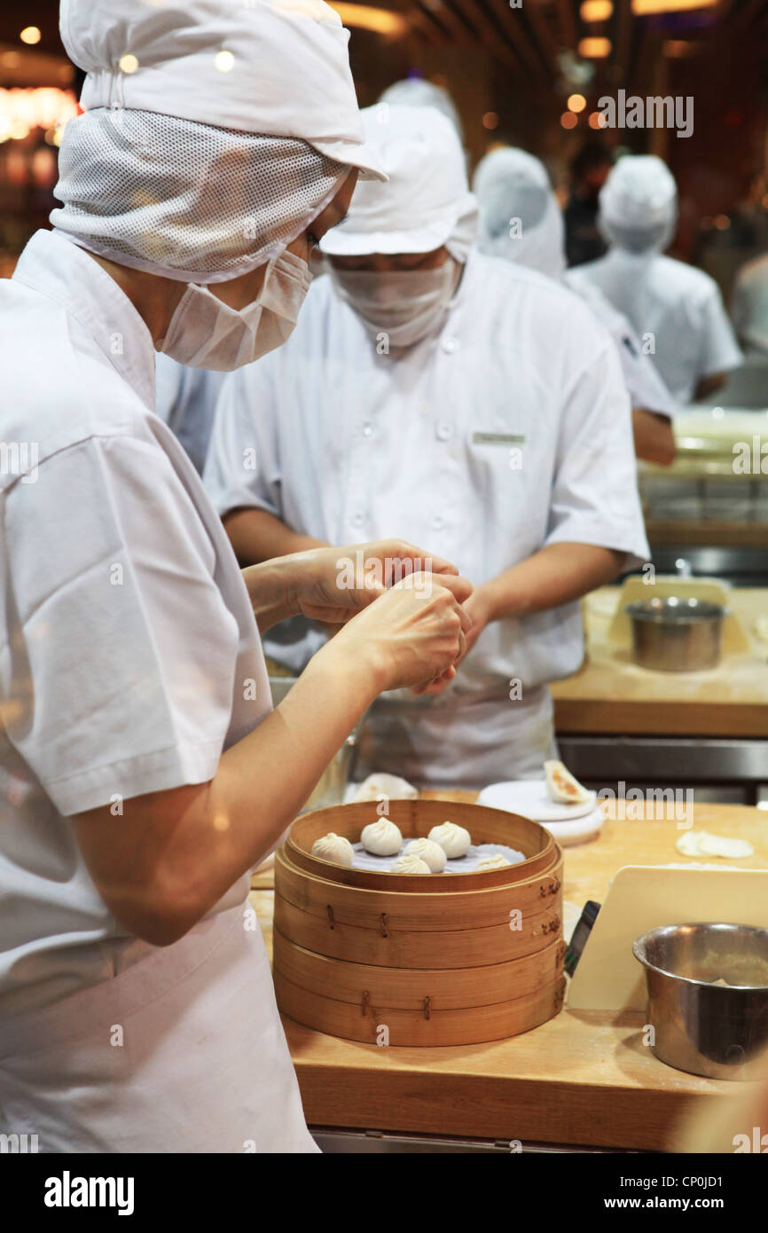 In this image, the chefs of a Chinese restaurant chain prepare ...