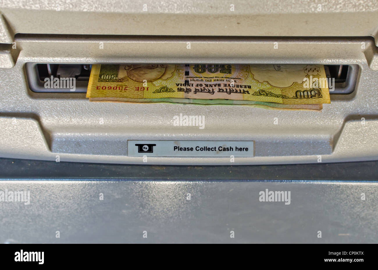 Cash coming out of atm slot Stock Photo - Alamy