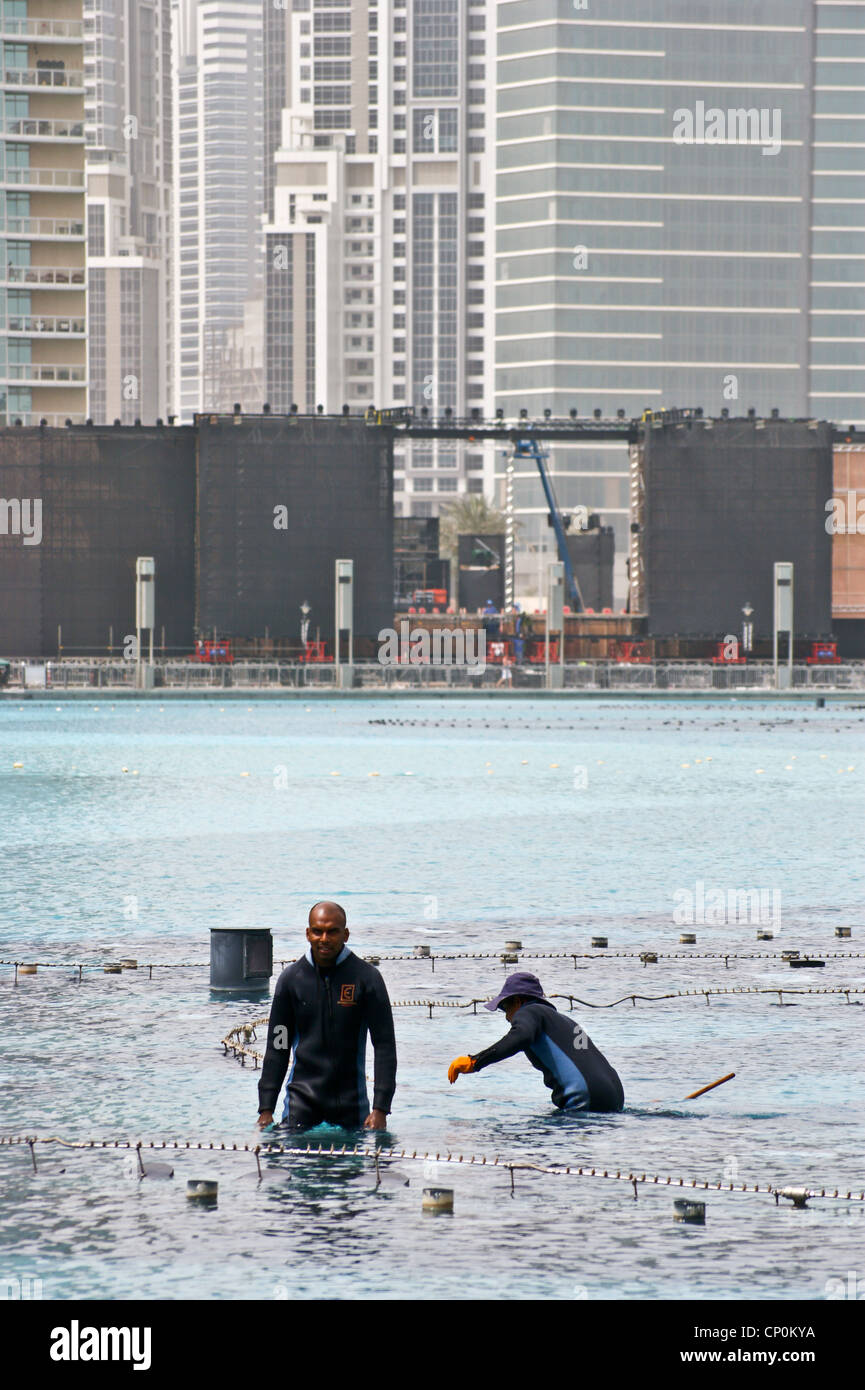 Divers clean the Dubai Fountain, Burj Khalifa Lake, Dubai, United Arab ...