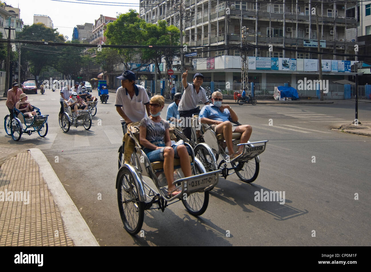 Horizontal view of cycle rickshaws carrying Western tourists wearing ...
