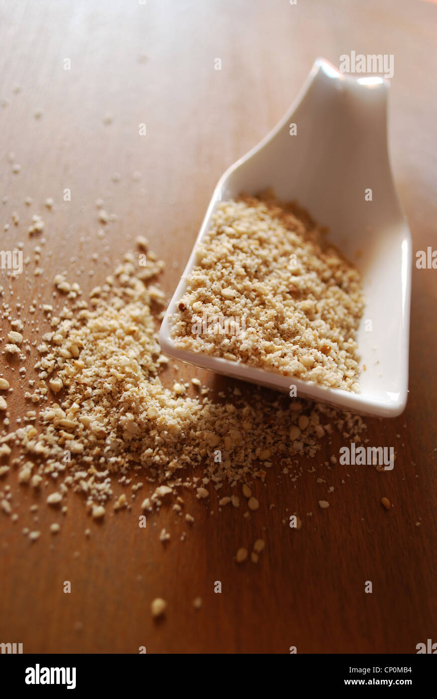 Gomasio made with sesam seeds and salt in white ceramic container on ...