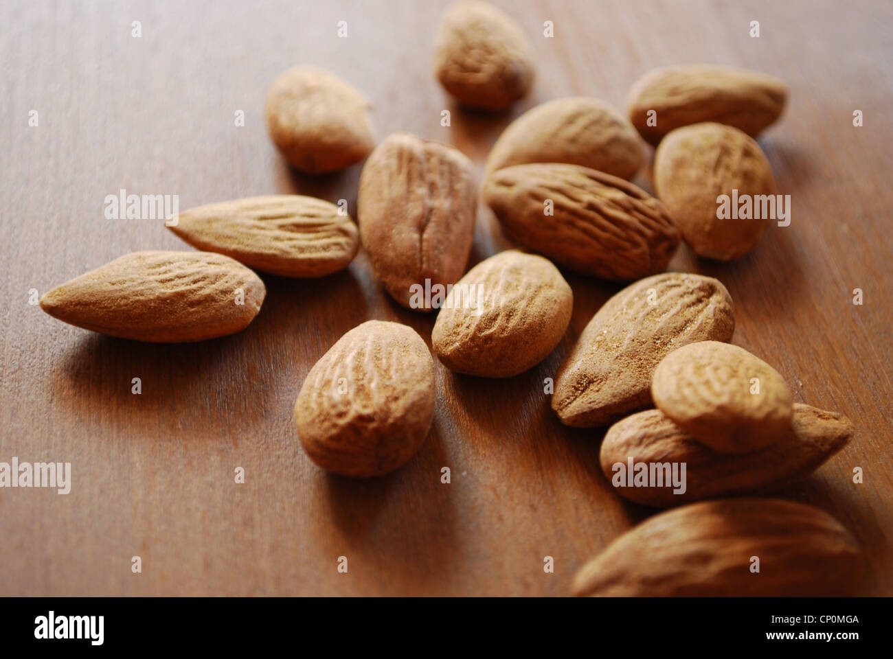 Shelled almonds on natural wooden table background Stock Photo - Alamy