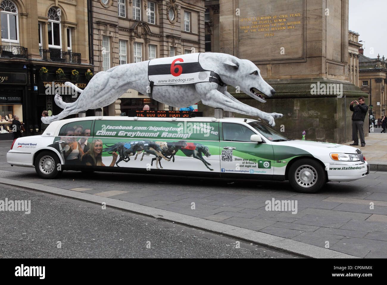 Stretched limo with large replica greyhound on the roof parked in the ...
