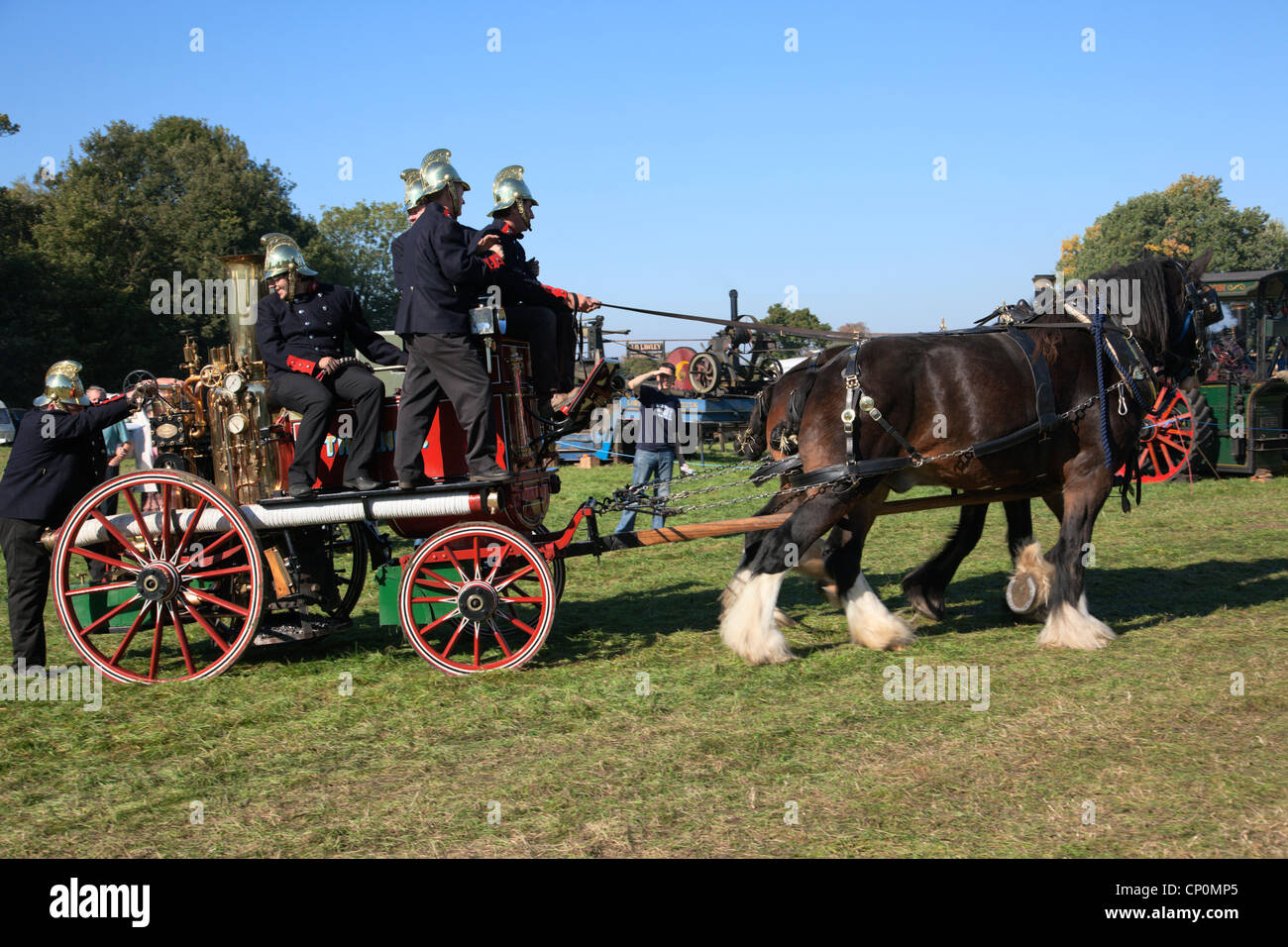 Horesdrawn fire engine driven by uniformed firemen Stock Photo - Alamy