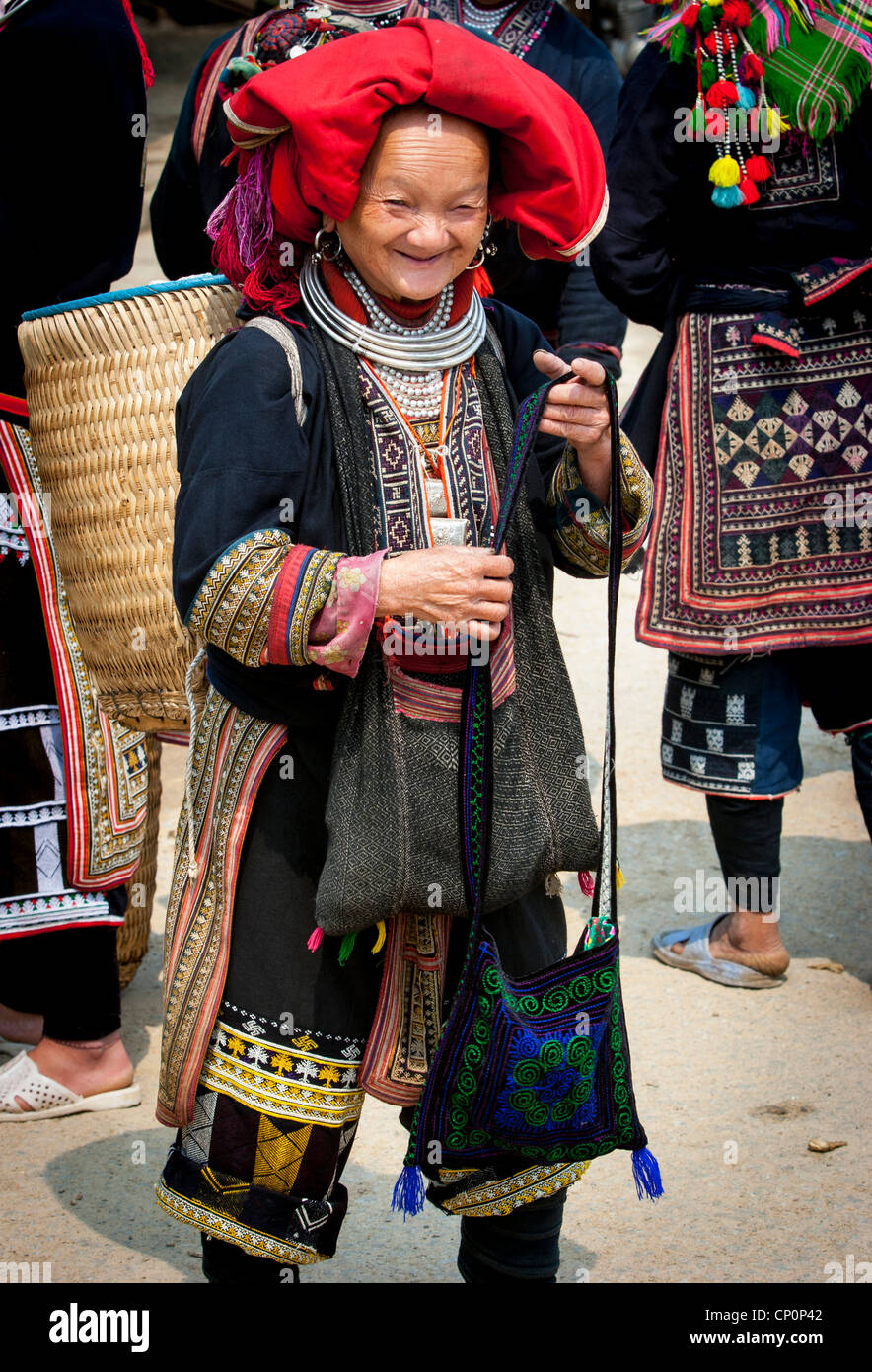An elderly woman of the Red Hmong tribe in Sapa, Viet Nam, wearing her ...