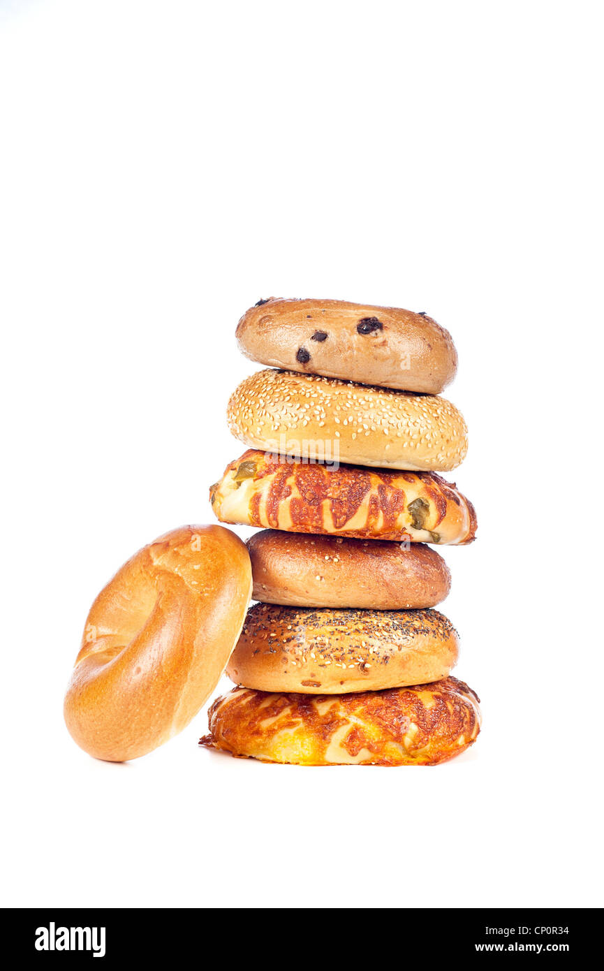 A stack of assorted, fresh, flavorful bagels on a white background ...