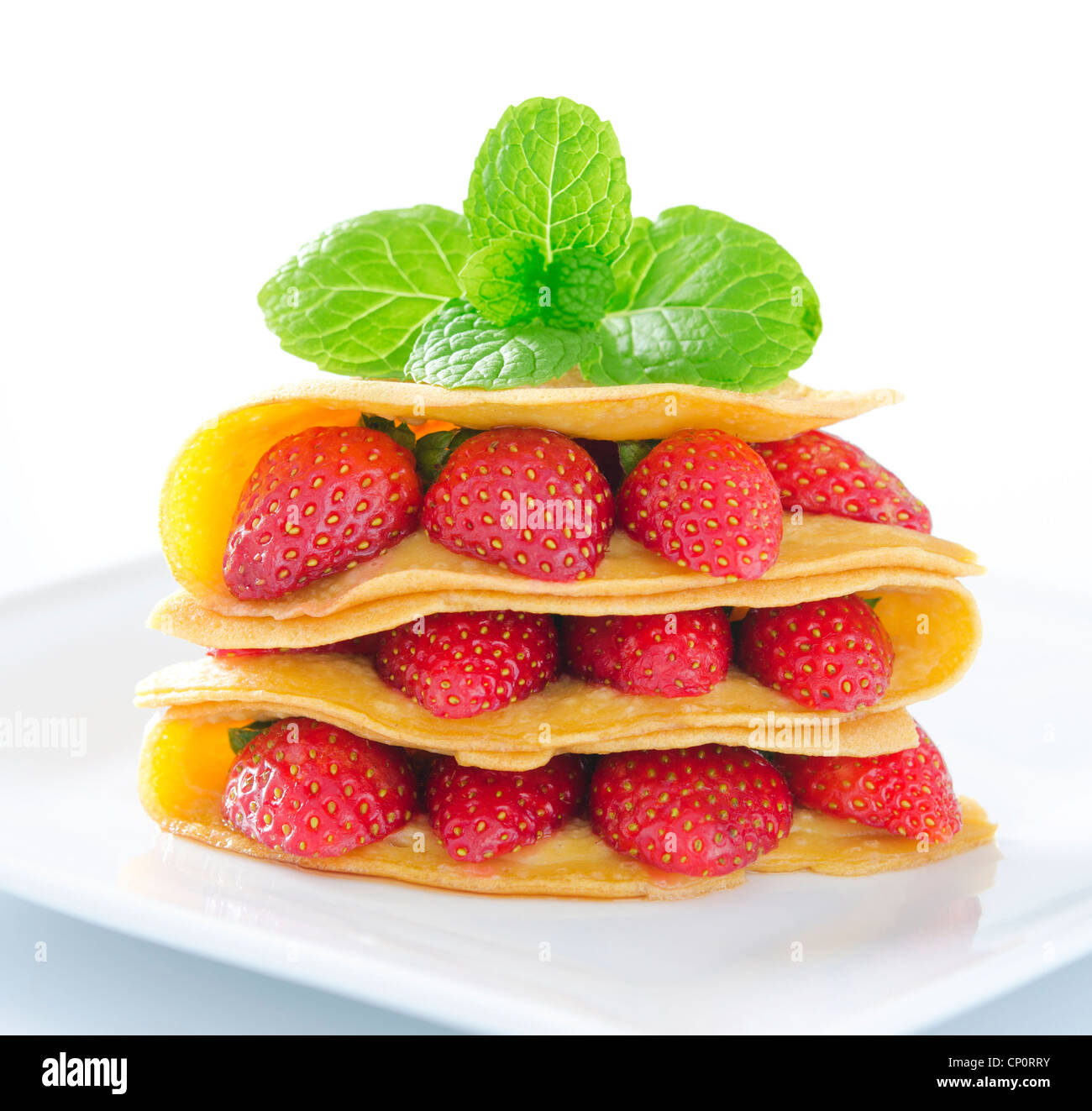 Strawberry slide cake, mint leaf topping Stock Photo - Alamy