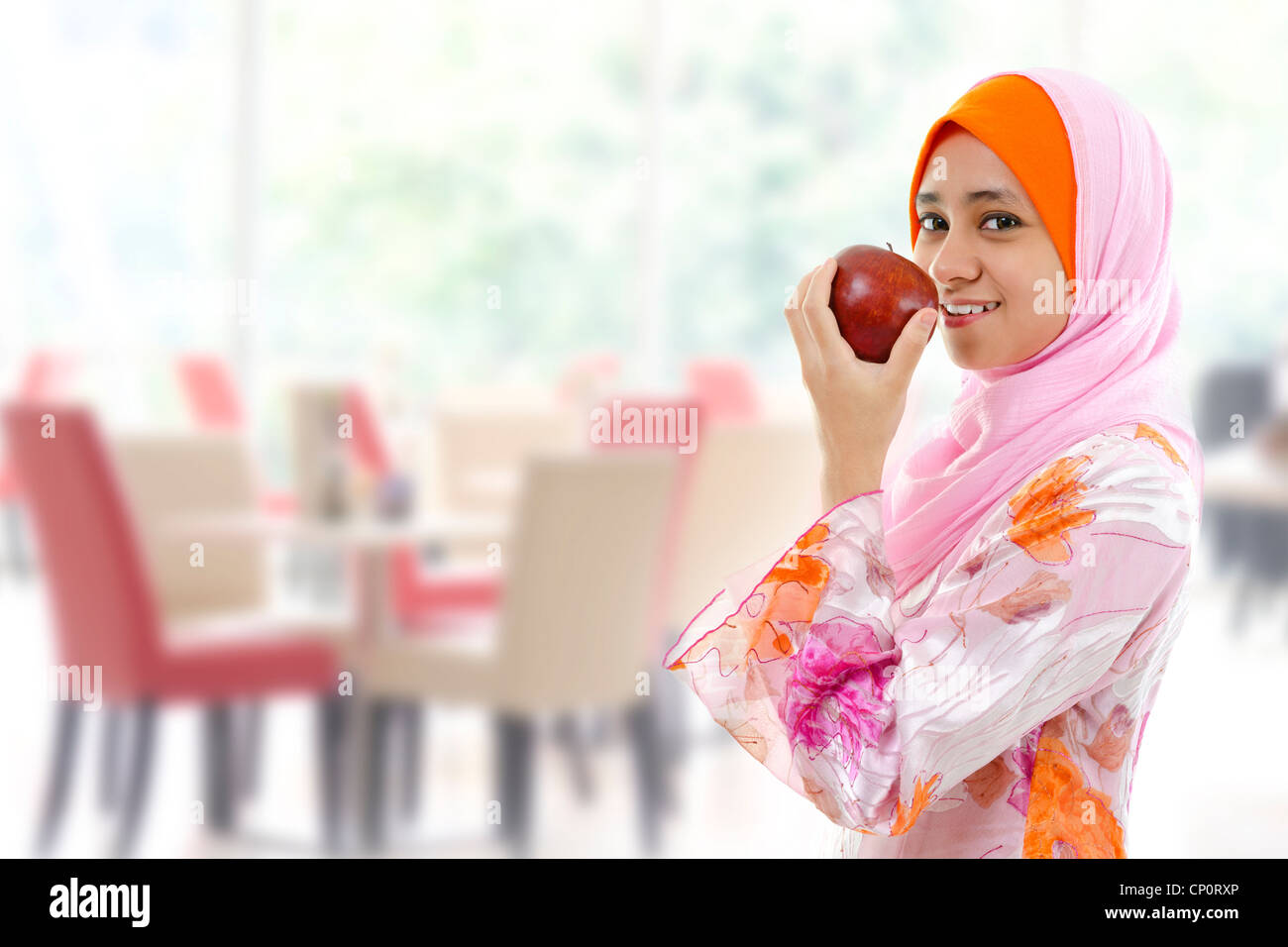 Young Muslim woman eating apple, healthy eating concept Stock Photo - Alamy