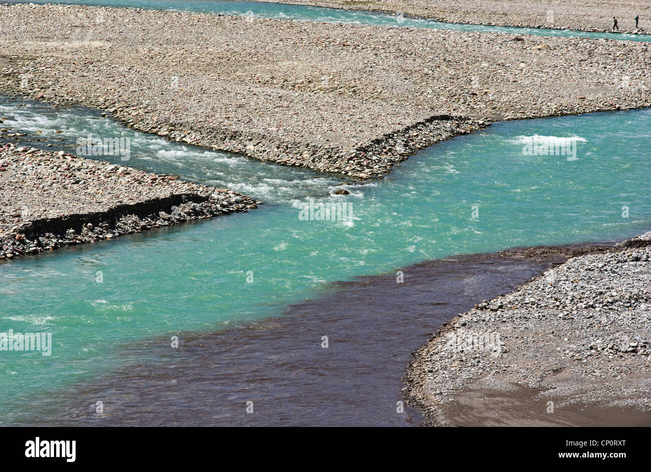 Small cocoa-colored tributary stream joining blue river Pin in Pin ...