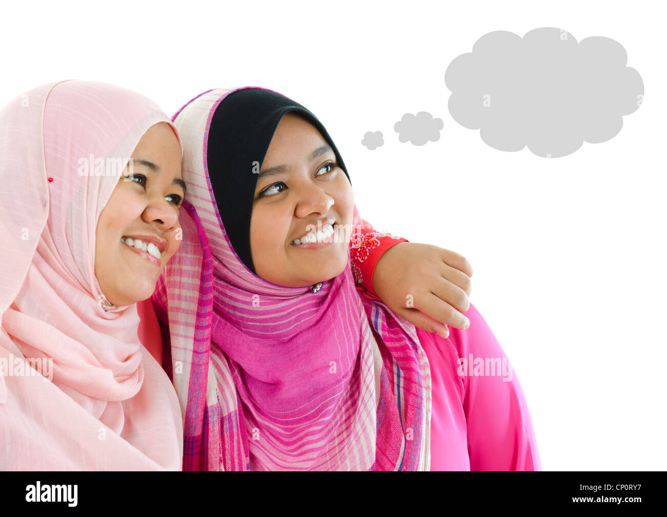 Two Muslim women having thought together, looking at side Stock Photo ...