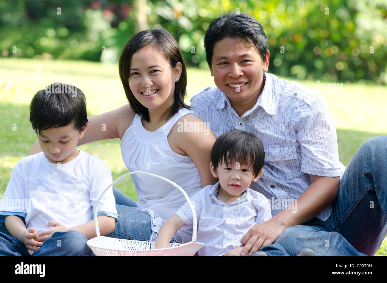 asian family with green background Stock Photo - Alamy